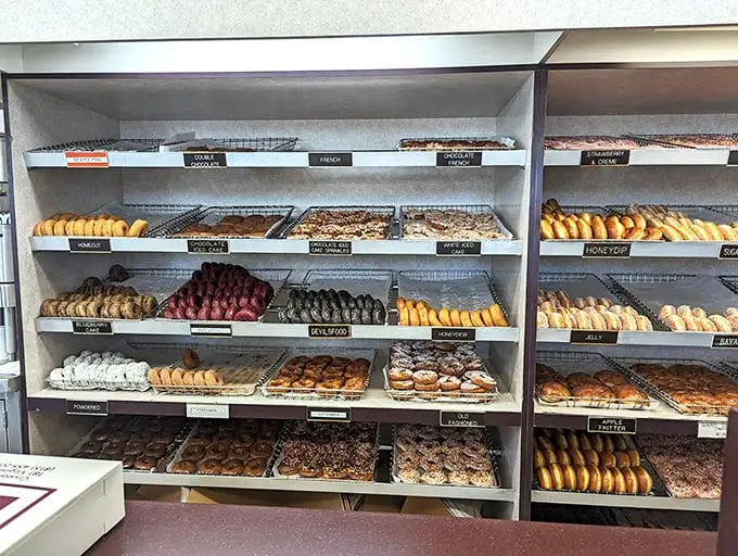 The display case—a museum of possibility where every shelf tells a different sweet story. Art that's meant to be eaten rather than observed.