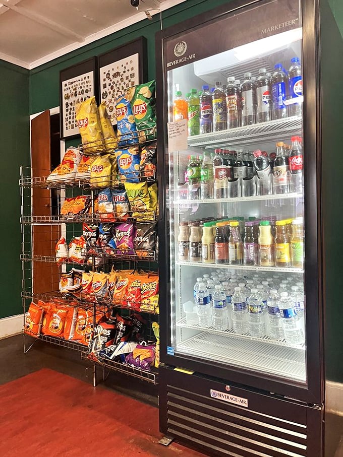 The wall of temptation—where chips and cold beverages stand ready to complete your sandwich experience with that perfect crunch and fizz.
