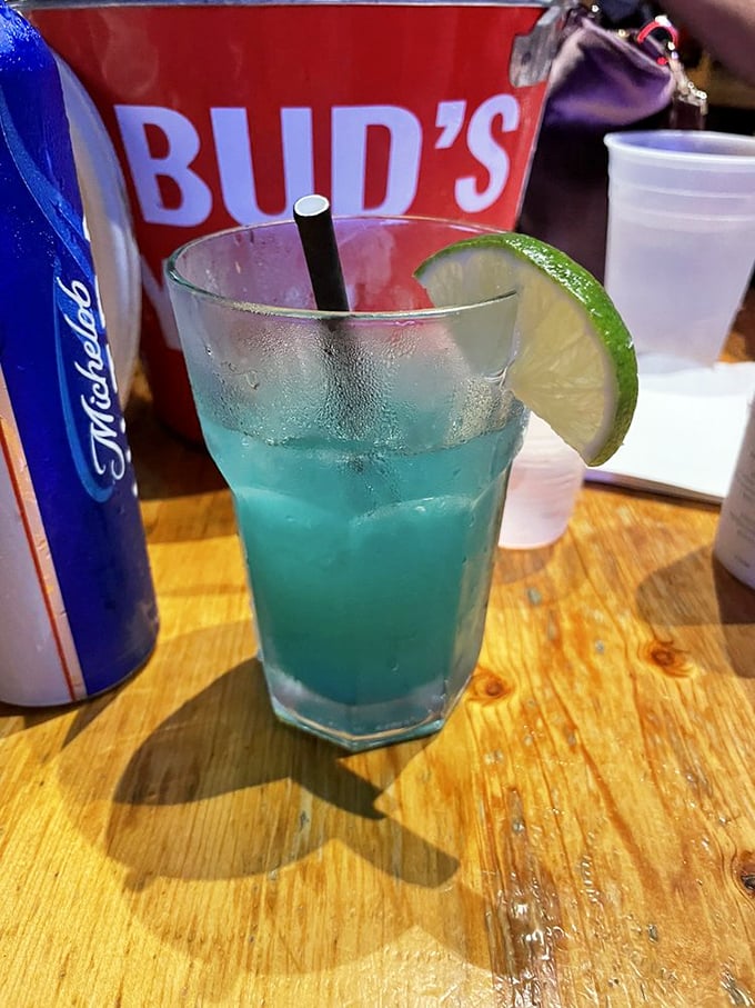 Electric blue cocktail with a lime garnish—like drinking a summer sky. The kind of drink that makes Monday feel like Friday.