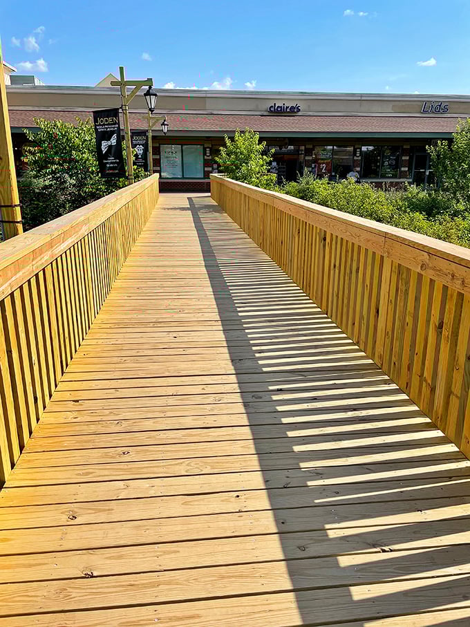This wooden footbridge doesn't just connect stores—it's the pathway to retail therapy your therapist never prescribed.