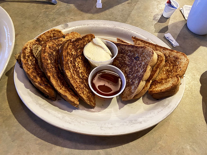 French toast stacked higher than your weekend plans, with dipping cups standing by for those who understand breakfast is serious business.