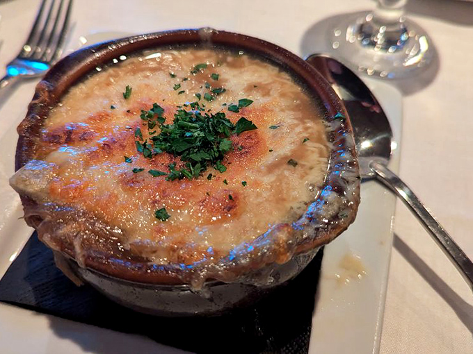 French onion soup that's achieved the perfect cheese-pull-to-broth ratio – a bubbling cauldron of comfort that's worth every inevitable dry-cleaning bill.