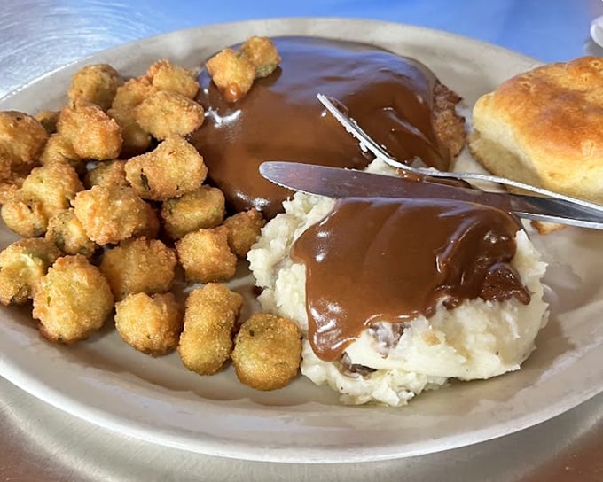 Mashed potatoes swimming in gravy so good you'll want to dive in after them, with fried okra standing by as delicious lifeguards.