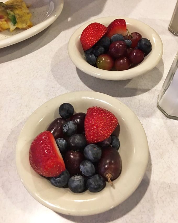 These fruit cups aren't just healthy side options – they're little bowls of jewel-toned morning optimism nestled against white ceramic.