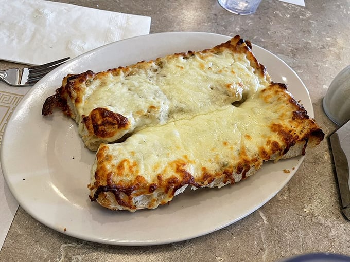 Garlic cheese bread that makes first dates dangerous and return visits mandatory—the perfect balance of crisp exterior and pillowy inside.