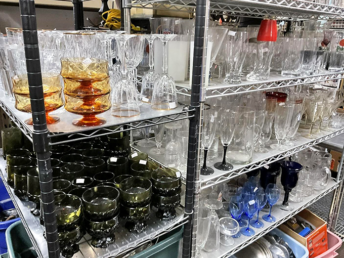 Crystal and colored glass catch the light like liquid rainbows – these shelves of vintage stemware are ready to elevate your next dinner party. 