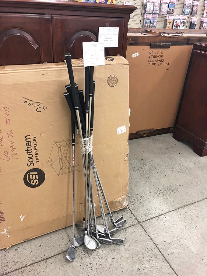 Golf clubs leaning casually against furniture boxes – because someone's abandoned hobby is about to become your new weekend passion.