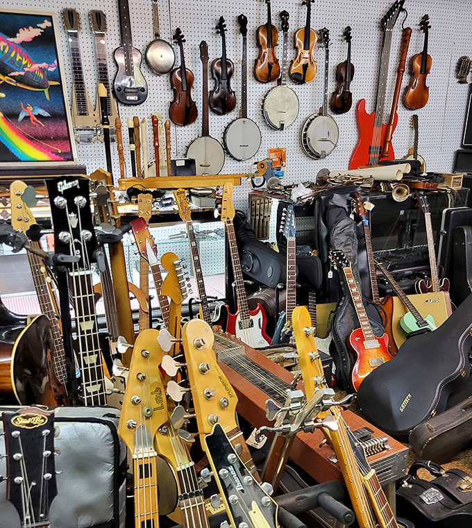 The wall of sound! Vintage guitars and banjos that might have played everything from bluegrass on Appalachian porches to garage band rock.