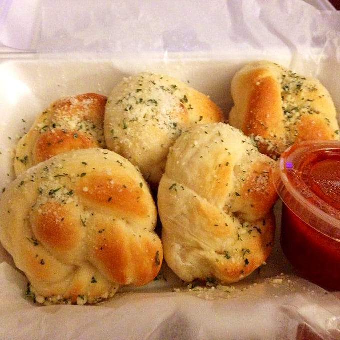 Garlic knots that demand to be torn apart and dunked. Pillowy dough, garlic butter, and that marinara sidekick.