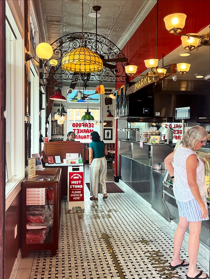 The host stand – that magical gateway between hunger and happiness, where the promise of paper-plated perfection begins.