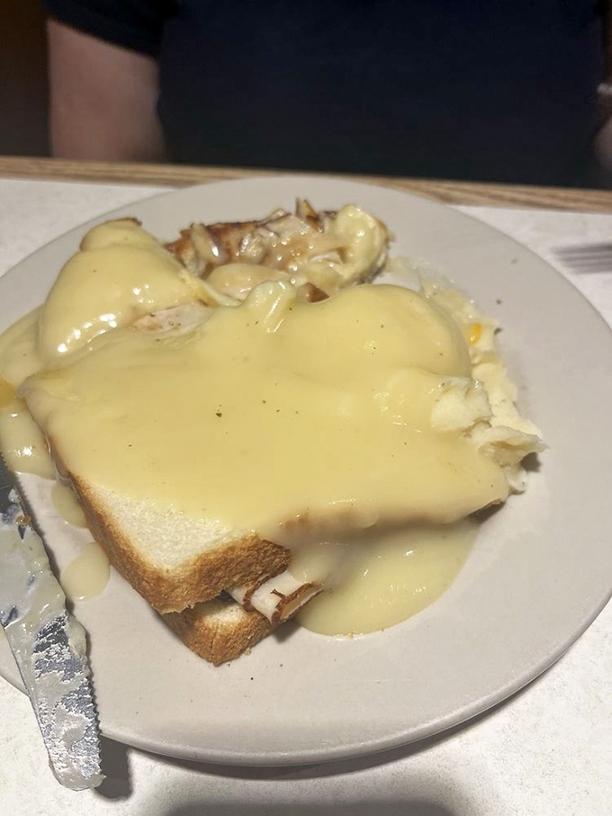 Hot turkey sandwich swimming in gravy – the kind of comfort food that makes you want to call your mother and thank her for everything.