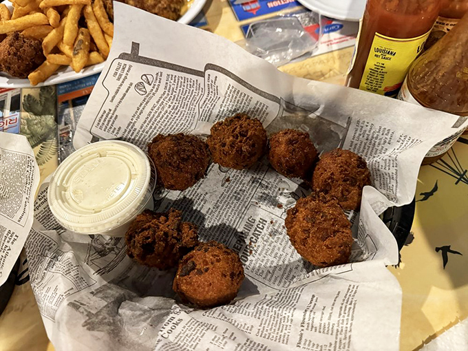 Hush puppies served newspaper-style, like little golden orbs of cornmeal joy that whisper, "You can have just one more."