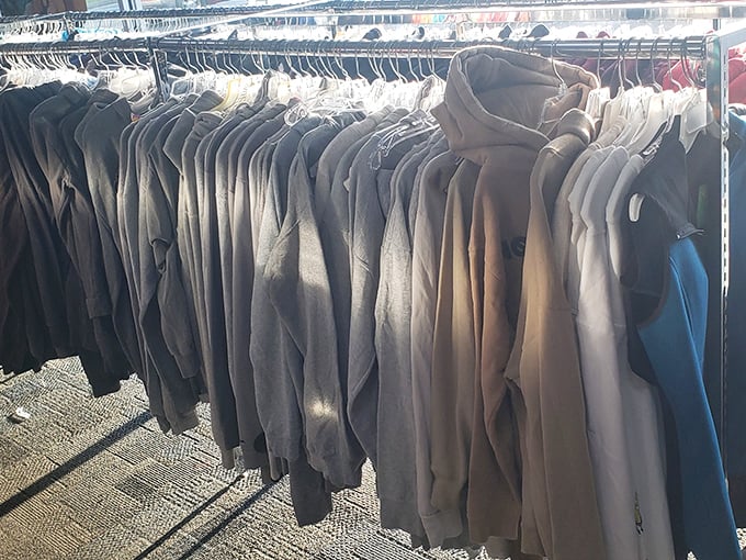 The clothing racks offer a monochromatic sea of business casual options—proof that building a professional wardrobe doesn't require a professional salary.