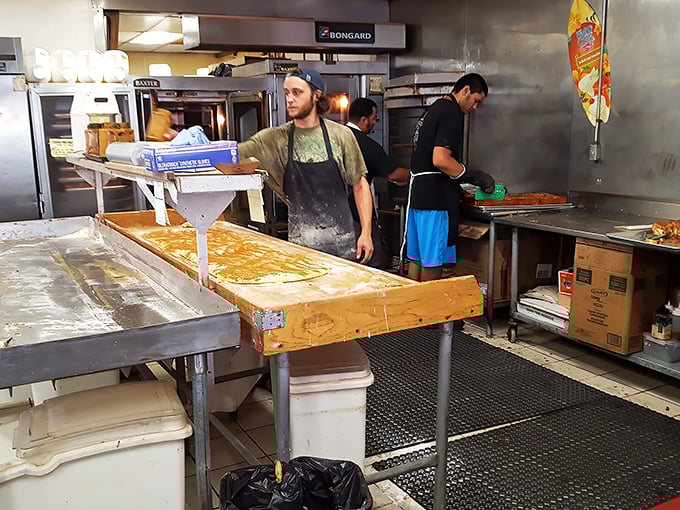 Behind the scenes magic: where dough becomes legend. Like watching Michelangelo, except the masterpiece is edible and smells better.