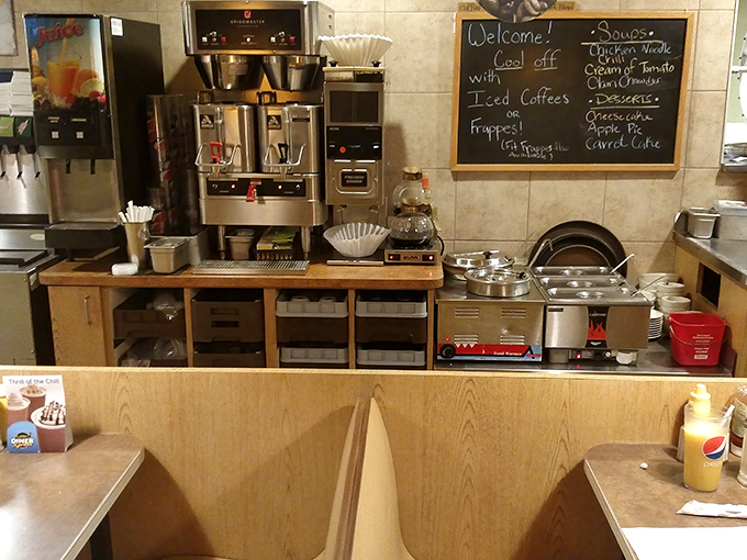 The coffee station—command central for morning revival operations. That chalkboard menu promises comfort in every cup and bite.