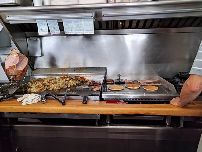 The kitchen's flat-top grill – where pancake batter transforms into golden discs of joy while home fries achieve crispy perfection.