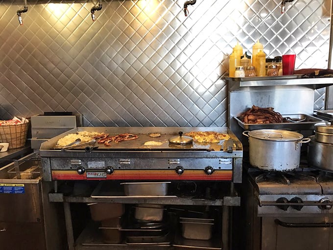 Behind the diamond-pattern backsplash lies the beating heart of Nadine's – a kitchen where breakfast magic happens without smoke, mirrors, or pretension.