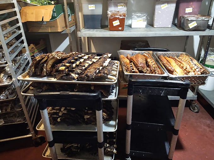 Behind the scenes where the magic happens – racks of ribs waiting for their moment of flame-kissed glory.