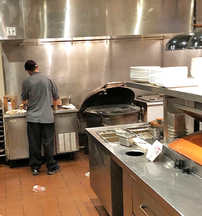 Behind the scenes where the magic happens—that open kettle grill isn't just equipment, it's the beating heart of the restaurant's philosophy.