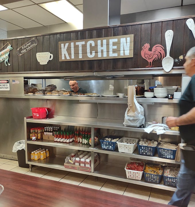 The kitchen sign says it all—this is command central where breakfast dreams become reality through the magic of short-order cooking.