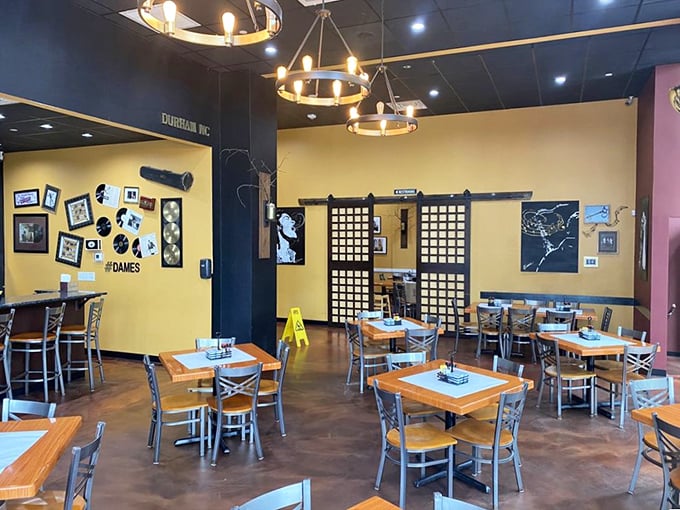 Modern chandeliers illuminate the dining space where jazz-inspired décor sets the stage for culinary performances.