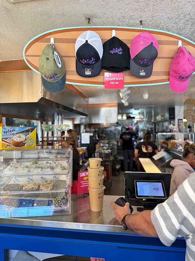 Splash Café merch displayed on a surfboard – because the only souvenir better than memories is a hat that tells everyone where you got those memories.