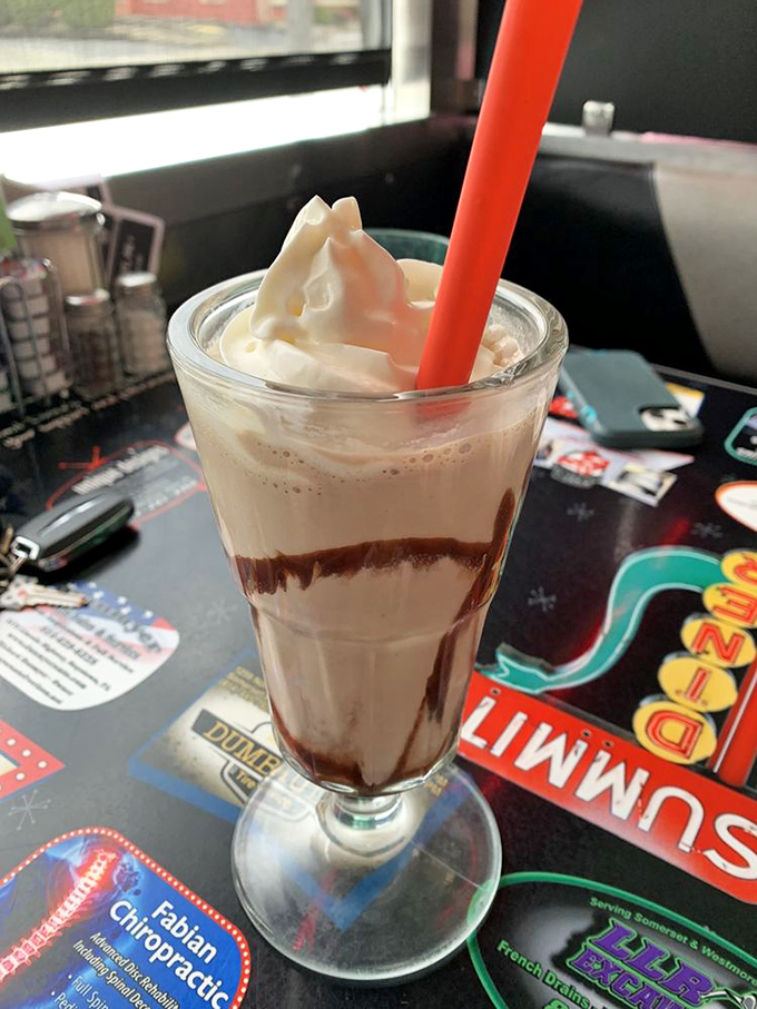A chocolate milkshake so thick your straw stands at attention—the perfect companion for diner deliberations or post-hike recovery.