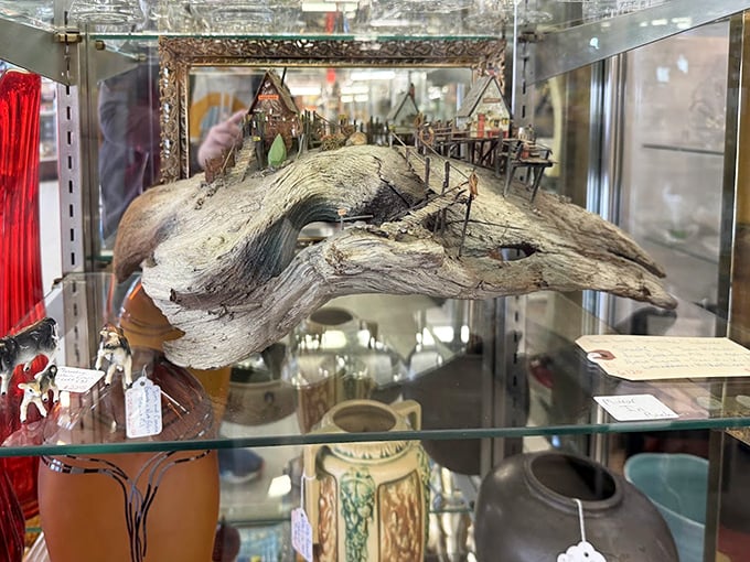 Not just driftwood, but a miniature world built upon it—proving that yesterday's beach trash becomes today's masterpiece with enough imagination and tiny figurines.
