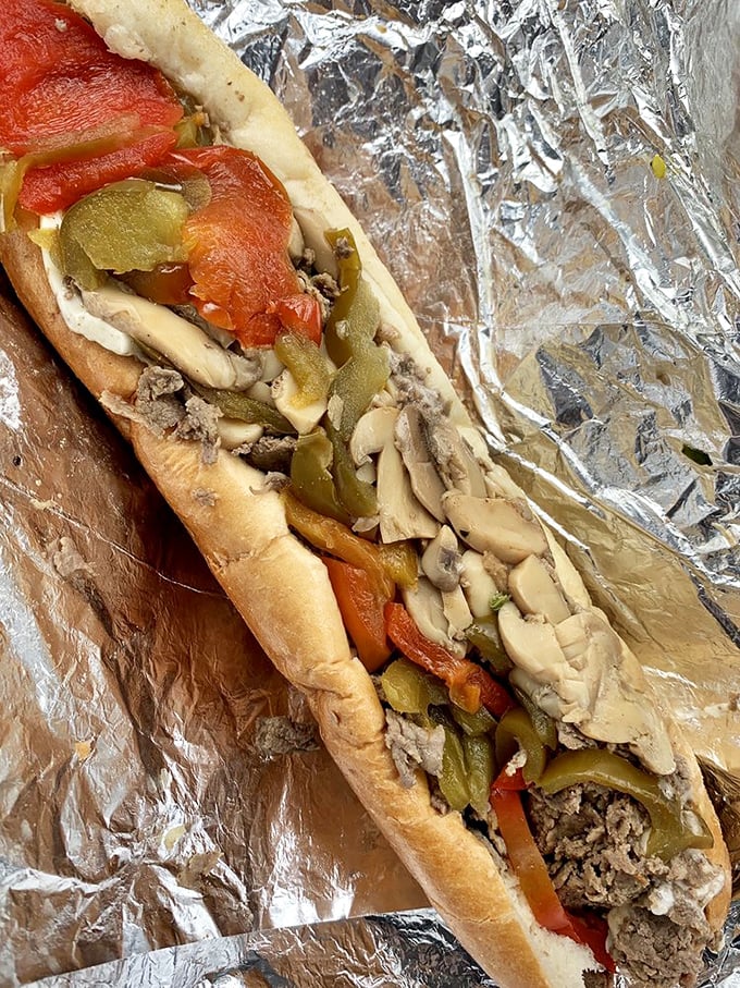A mushroom cheesesteak that makes vegetarians question their life choices. The marriage of earthy mushrooms and melty cheese is pure sandwich bliss.