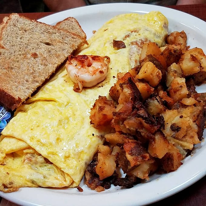 An omelet that's clearly been to culinary school, graduating with honors in fluffiness and generous filling distribution.