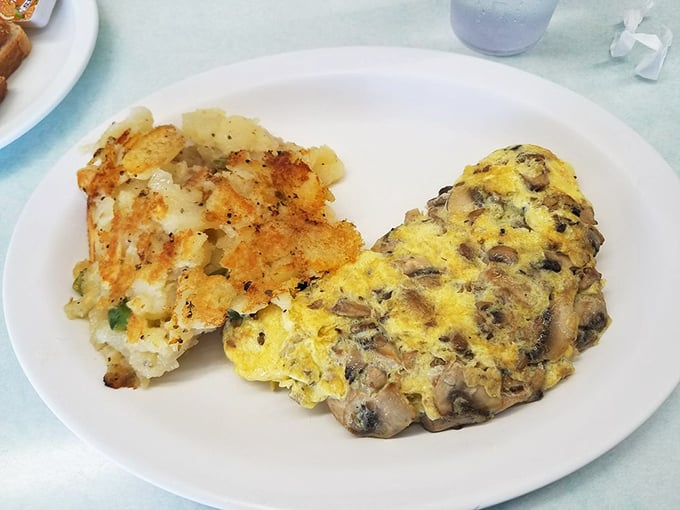 A mushroom omelet that's fluffy on the outside, stuffed with earthy goodness on the inside, and flanked by home fries that refuse to be overshadowed.