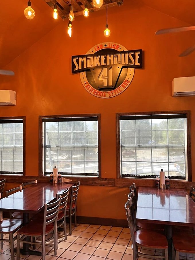 Warm orange walls and Edison bulbs create the perfect backdrop for the Smokehouse 41 logo – a promise of good things to come.