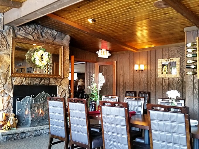 The stone fireplace anchors the dining room like a north star of hospitality, guiding hungry travelers to a place where comfort food truly comforts.
