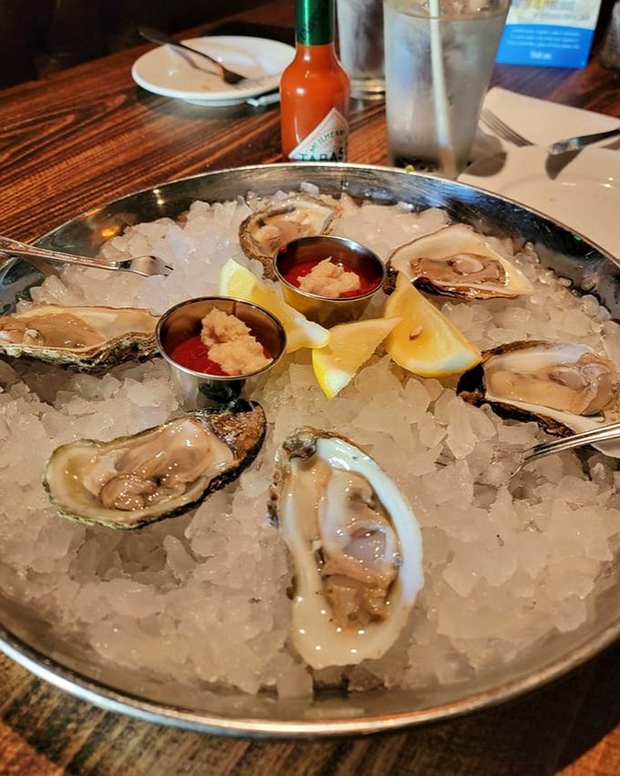 Fresh oysters on ice with lemon wedges and cocktail sauce – nature's perfect appetizer. The ocean's version of "Here's a little something to tide you over."