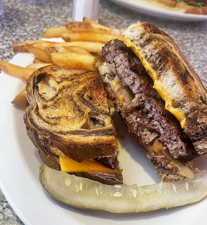 The patty melt—burger's sophisticated cousin—where grilled bread meets melted cheese in a symphony that makes you forget fancy dining exists.