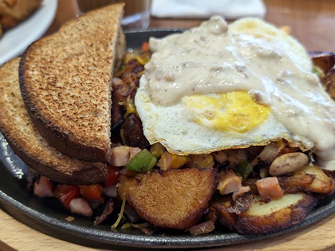 The breakfast skillet – where potatoes, eggs, and various breakfast meats gather for a morning meeting that always ends in unanimous satisfaction.