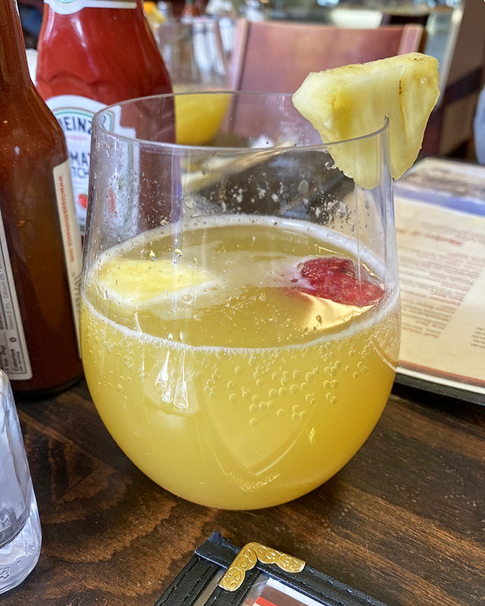 A mimosa garnished with pineapple—because vacation starts whenever you decide it does. Sunshine in a glass, Eastern Sierra style.