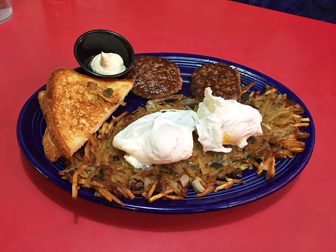 Breakfast perfection on a blue plate. Those hash browns are the unsung heroes – crispy on the outside, tender within, like the best of us.