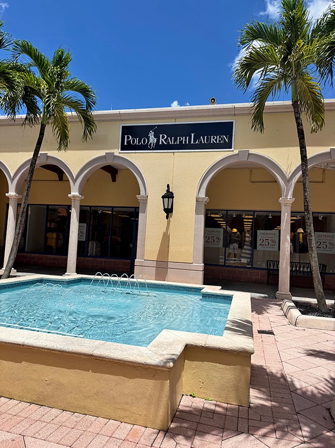Polo Ralph Lauren's storefront complete with fountain creates the illusion you're shopping at a fancy estate sale rather than an outlet mall in Florida City.