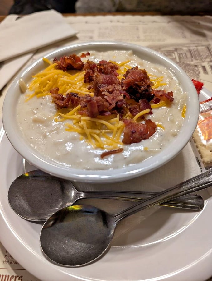 A bowl of potato soup topped with cheese and bacon—winter comfort that somehow tastes like a warm German kitchen feels.