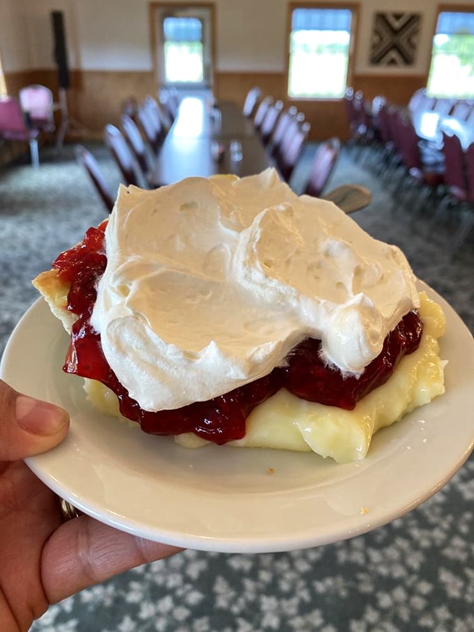 Layers of cream, fruit, and meringue creating a dessert skyscraper. Architecture you can eat with a spoon.
