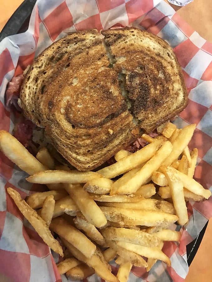The Reuben sandwich—where sauerkraut, corned beef, and Swiss cheese hold their annual meeting with a side of crispy fries.