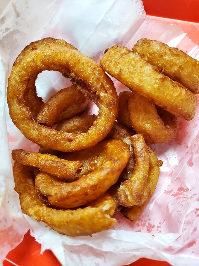 Onion rings with that perfect crunch—the kind that makes a satisfying sound that's music to a hungry person's ears.