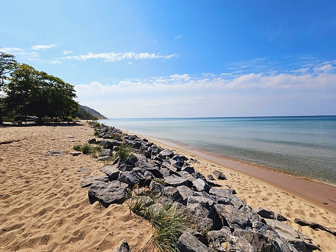 Where sand meets stone in nature's version of mixed media art. The rocks aren't obstacles—they're nature's way of saying "slow down and notice me."