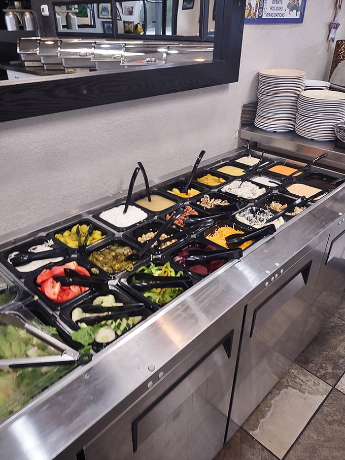 A salad bar that proves good things come in compartments—fresh vegetables and toppings waiting to transform ordinary lettuce into extraordinary lunch.
