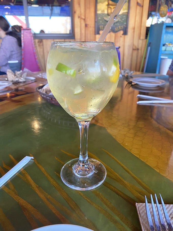 A refreshing lime-garnished cocktail that promises to cool you down while the seafood heats things up – summer in a glass.