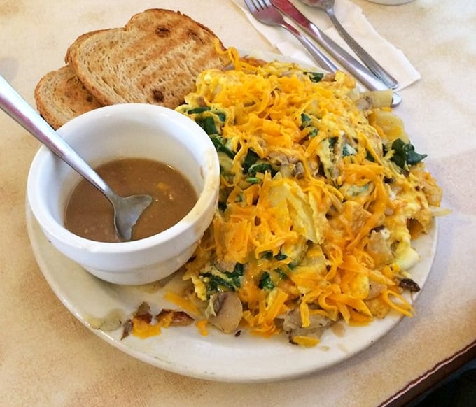 The Scrambler in its natural habitat—a mountain of potatoes, eggs, and vegetables under an avalanche of cheese that makes vegetables disappear like magic.