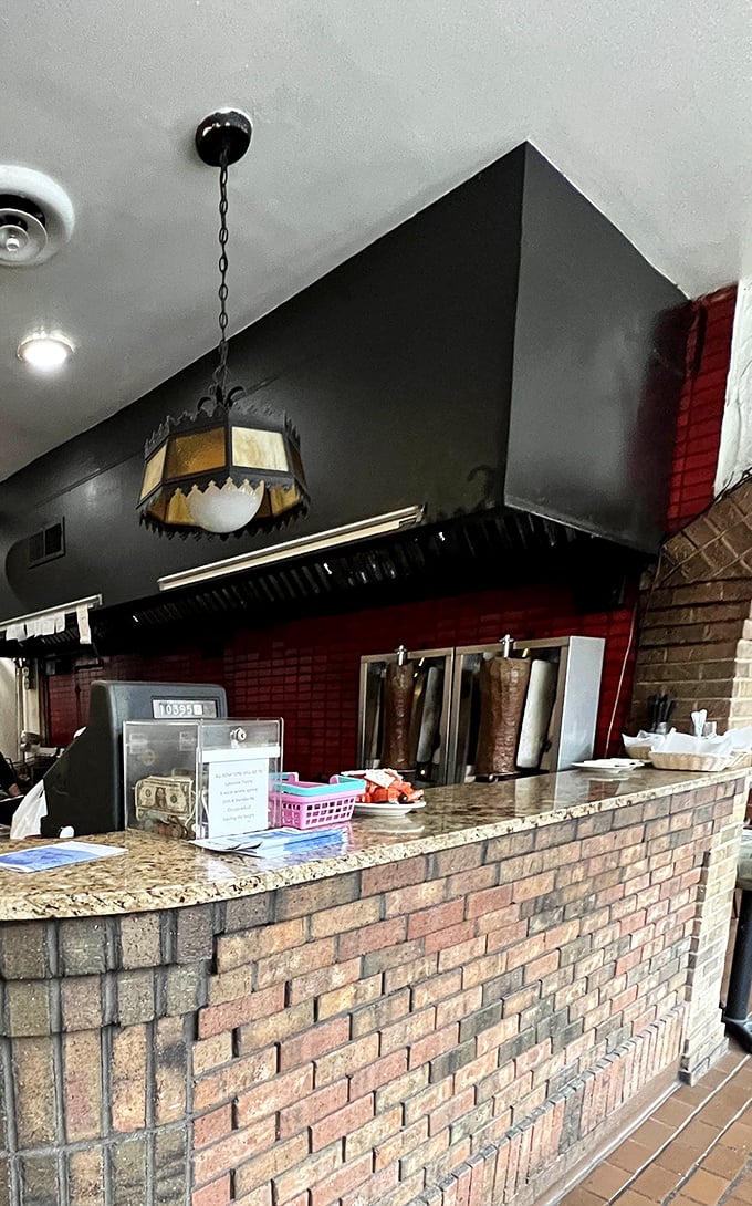 Behind this unassuming counter, culinary magic happens with the efficiency of a Greek orchestra—each movement precise and purposeful.