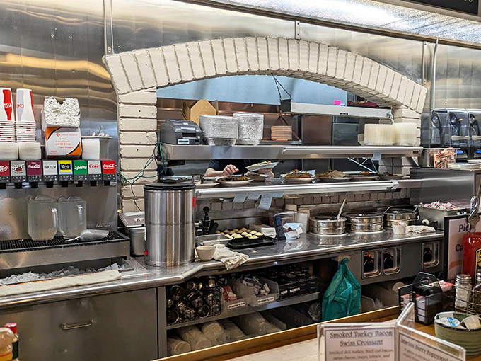 The kitchen pass—where culinary magic happens behind stainless steel, each order emerging like a gift from unseen hands.