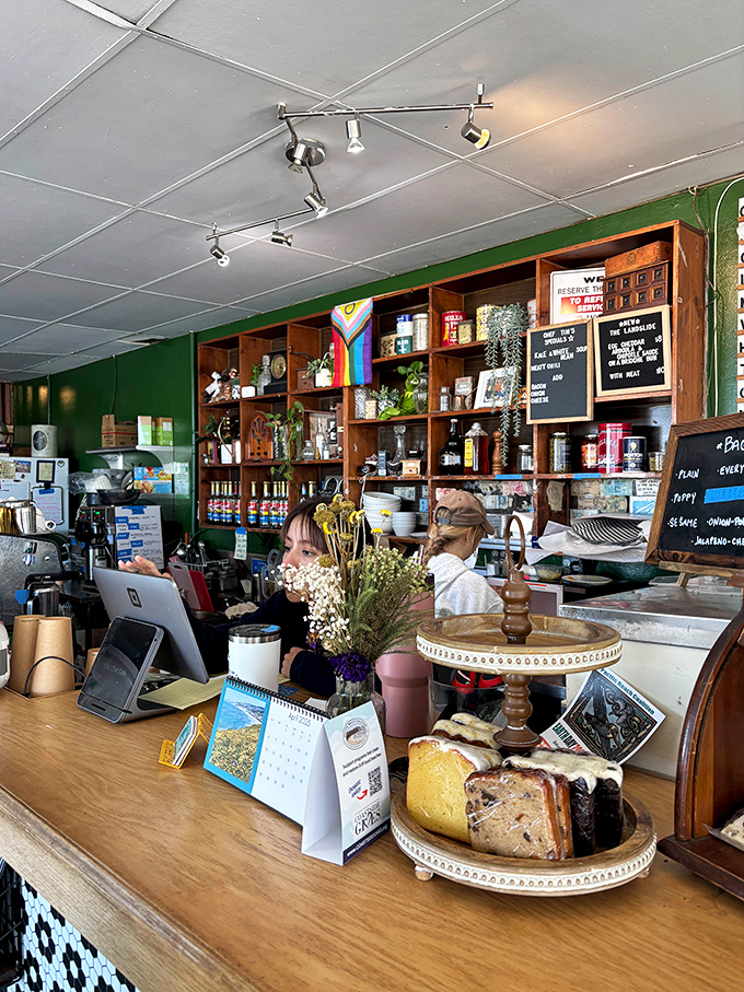 Behind the counter, organized chaos reigns—coffee equipment, pastry displays, and the quiet efficiency of a place that knows exactly what it is.